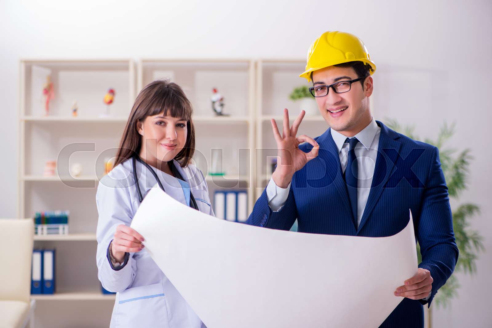 Doctor discussing new hospital plan with architect | Stock image ...
