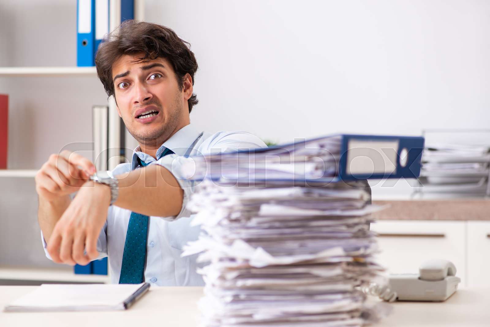 Overloaded busy employee with too much work and paperwork | Stock image ...