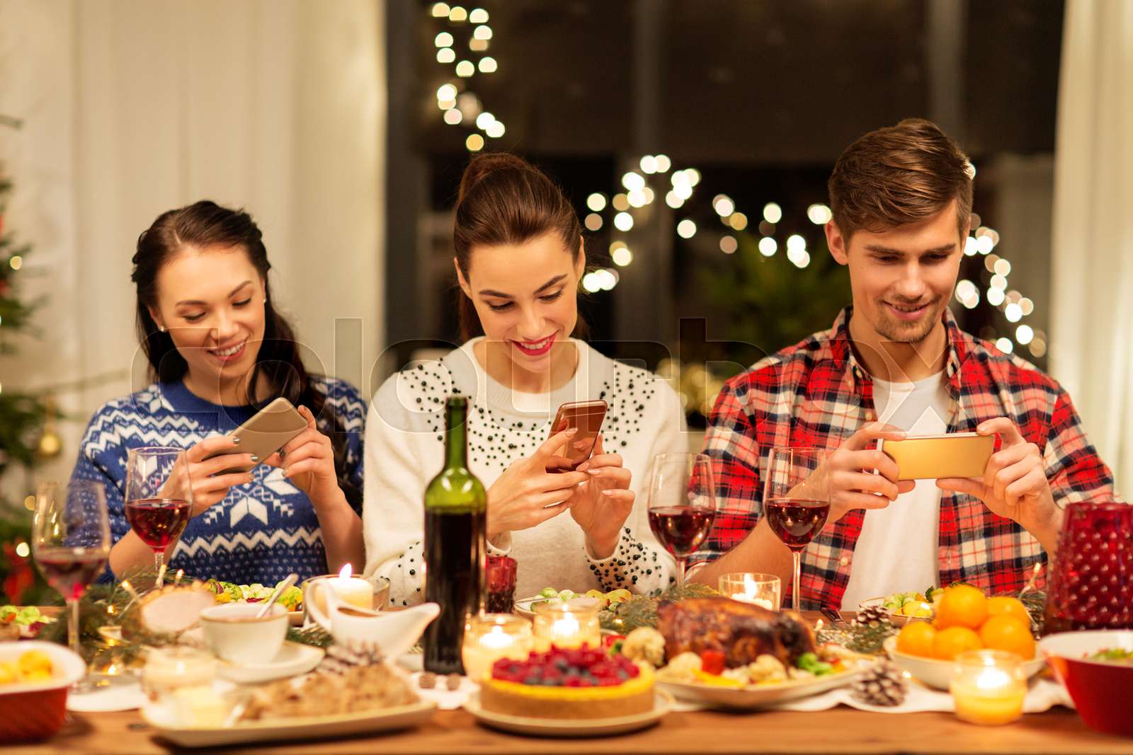 happy friends having christmas dinner at home | Stock image | Colourbox