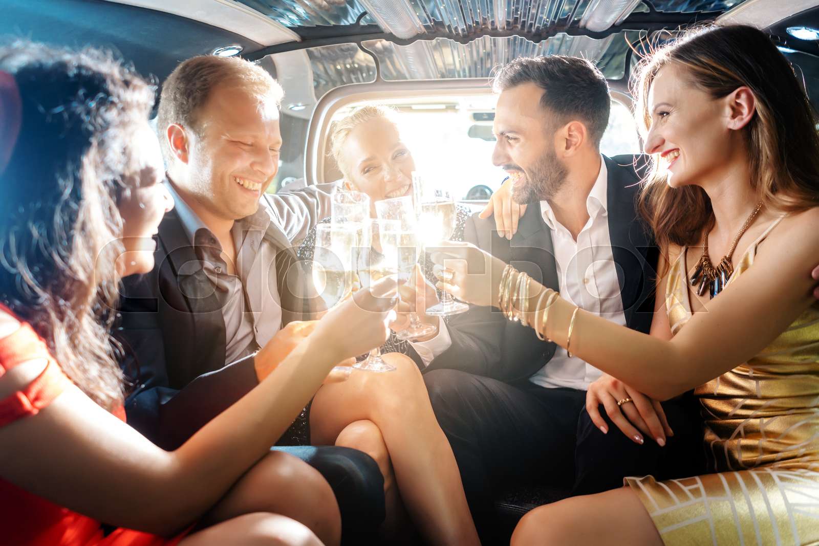 Crowd of party people in a limo with drinks | Stock image | Colourbox