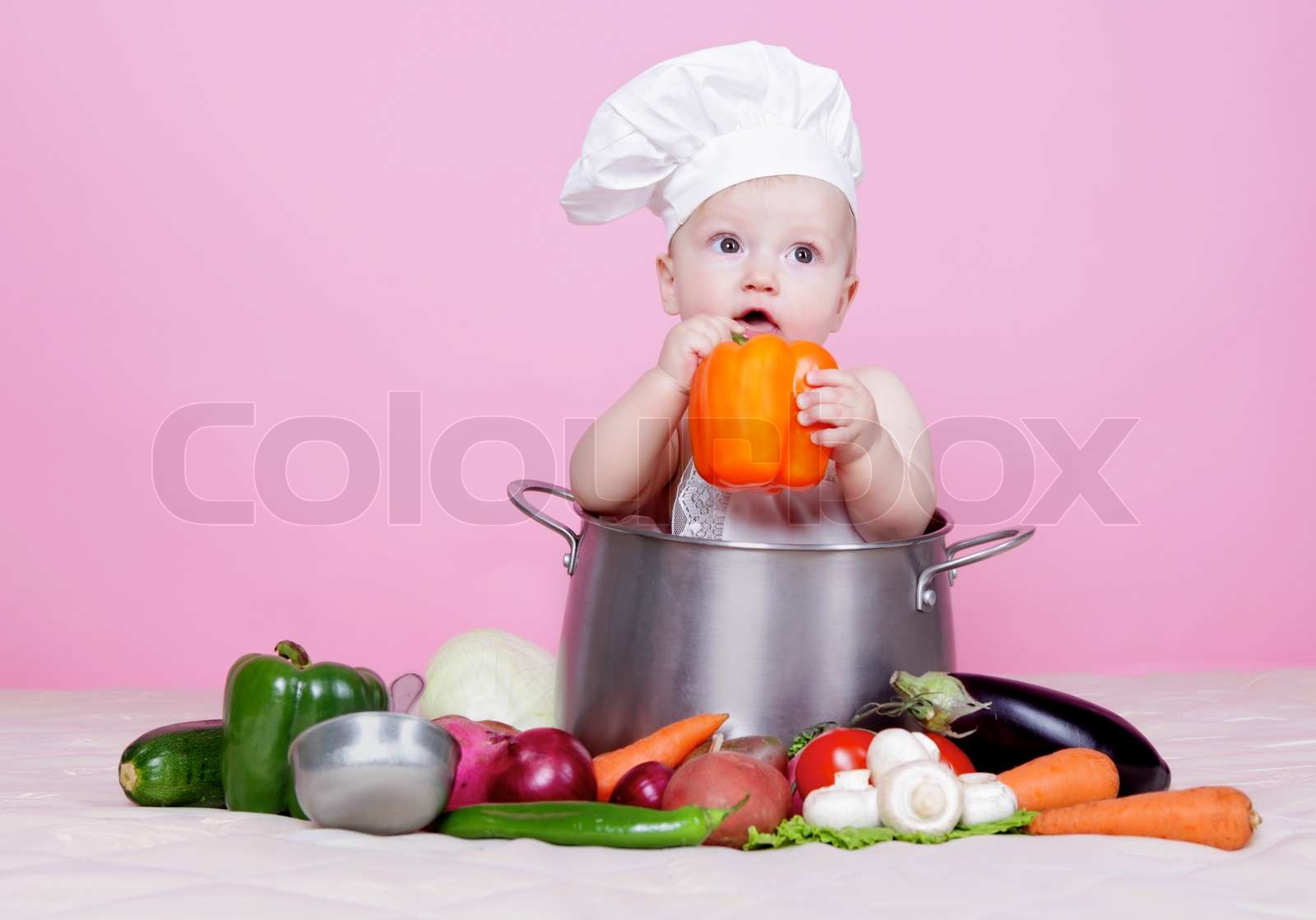 Baby cook with vegetables in studio | Stock image | Colourbox