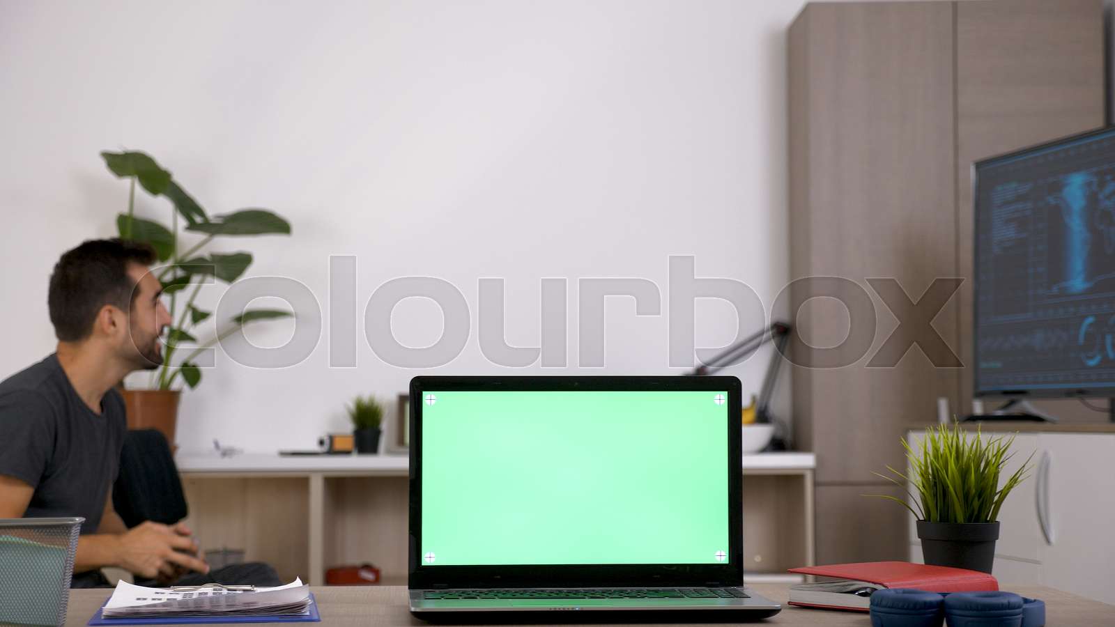 Green screen laptop with man behind playing video games. | Stock image ...