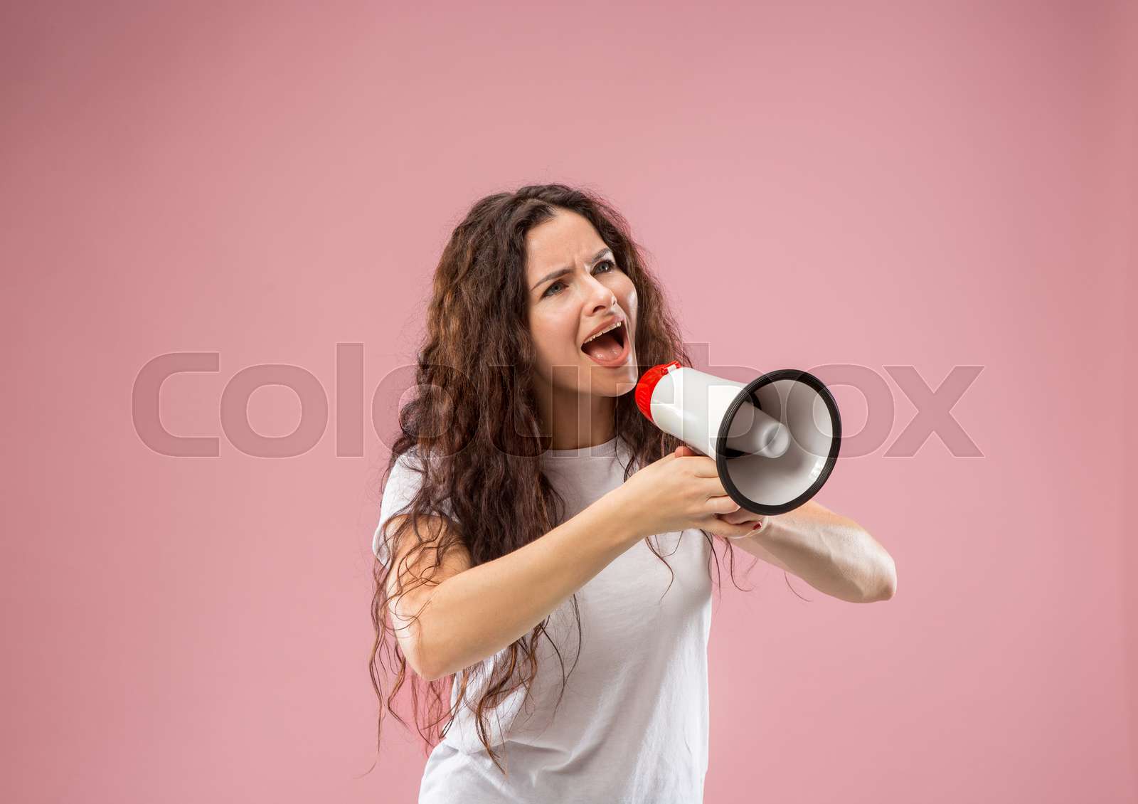 Woman making announcement with megaphone | Stock image | Colourbox