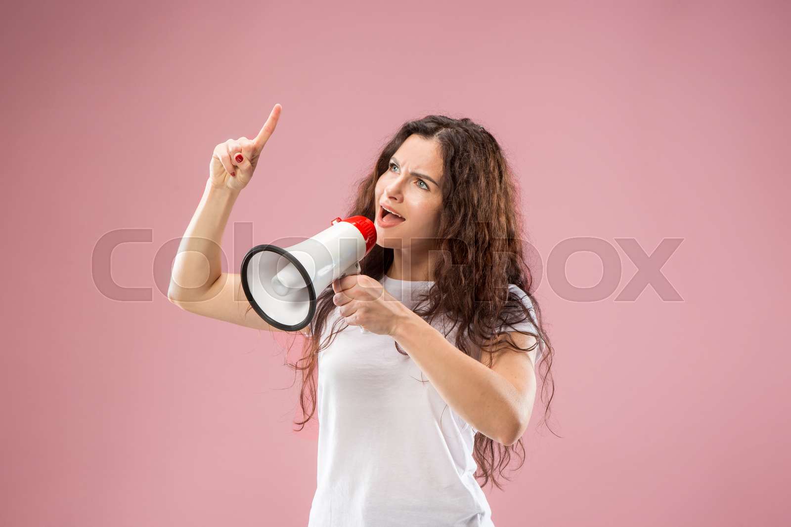 Woman making announcement with megaphone | Stock image | Colourbox