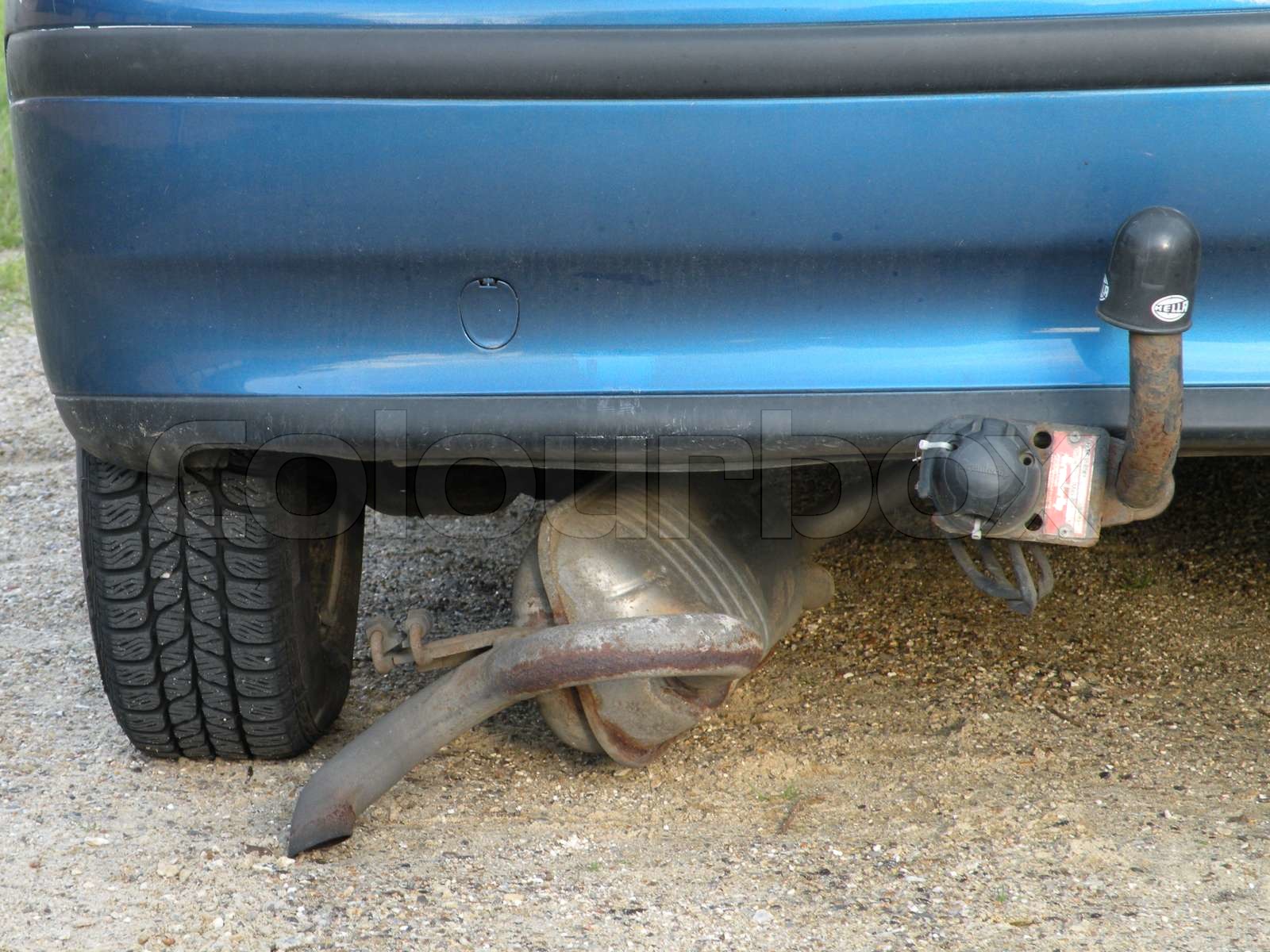 broken exhaust valve, tailpipe and muffler under a blue car | Stock ...