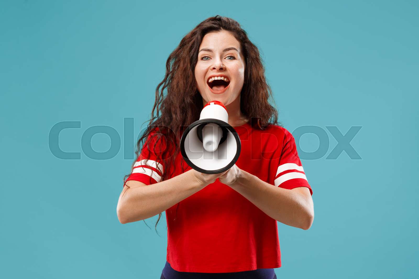 Woman making announcement with megaphone | Stock image | Colourbox