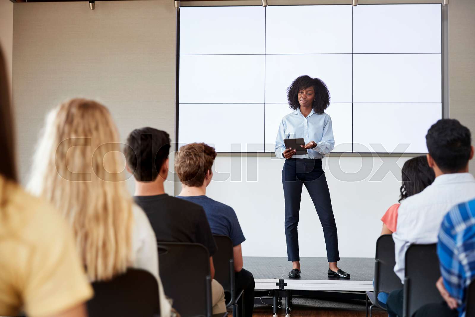 Female Teacher With Digital Tablet Giving Presentation To High School ...