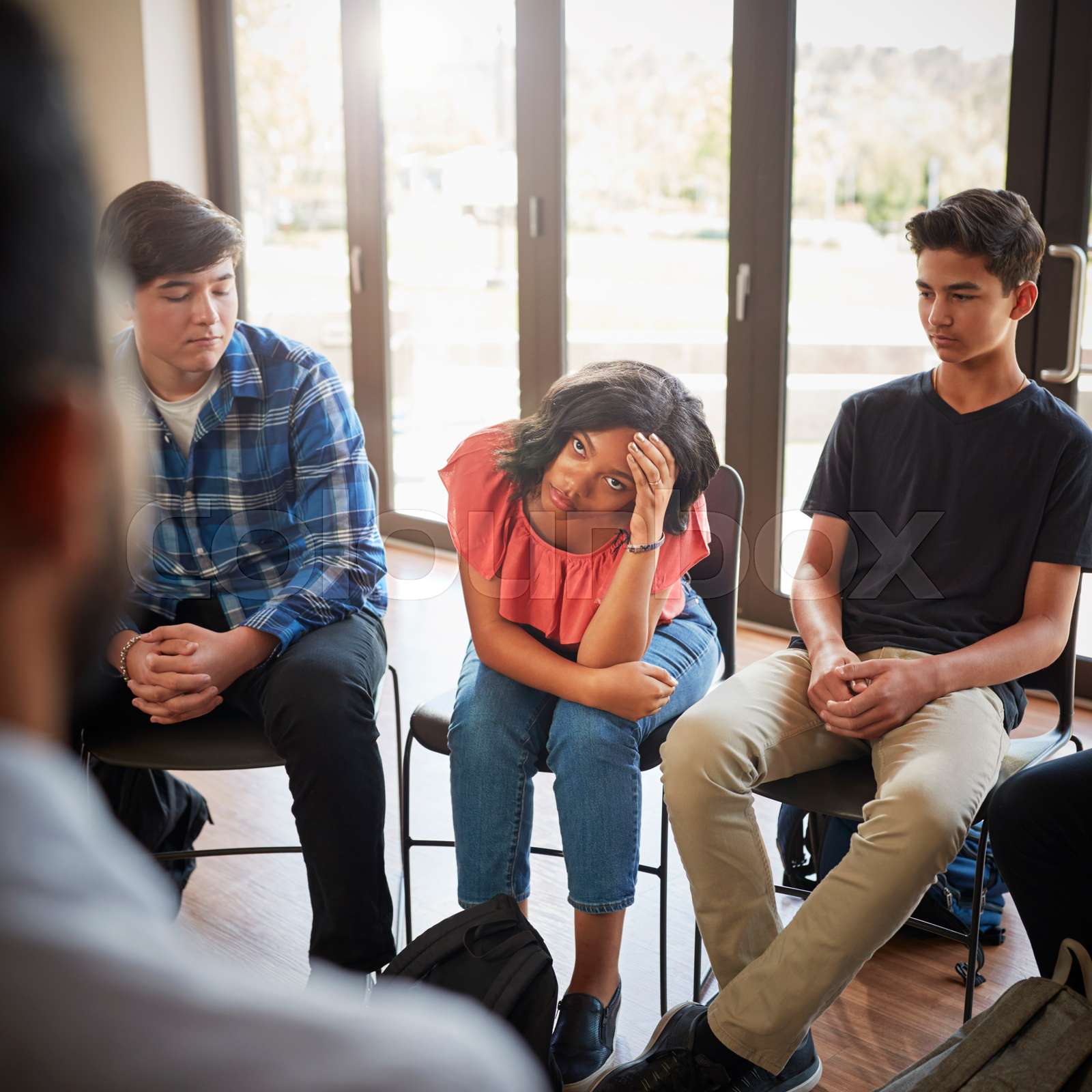 Unhappy Female Pupil In High School Discussion Group | Stock image ...