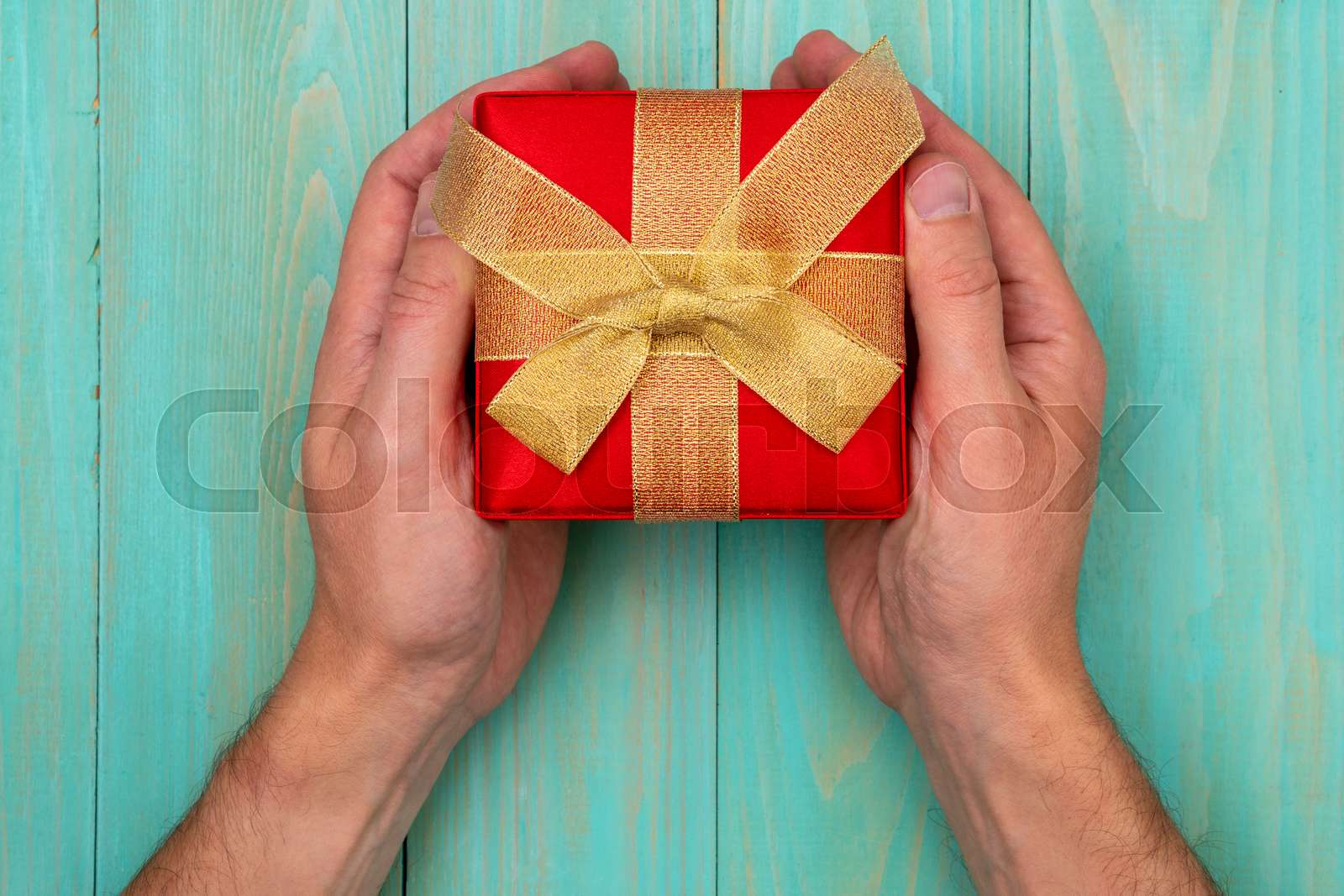 Hands with a gift | Stock image | Colourbox