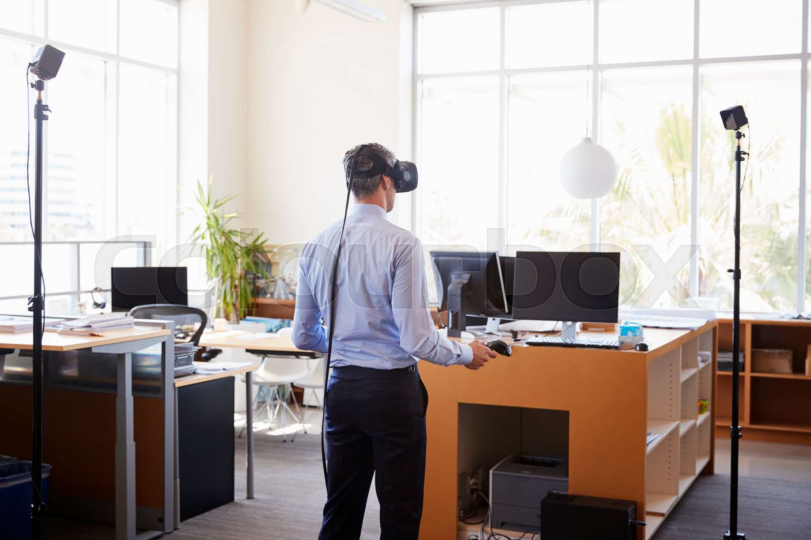 Businessman using VR technology in an office, back view | Stock image ...