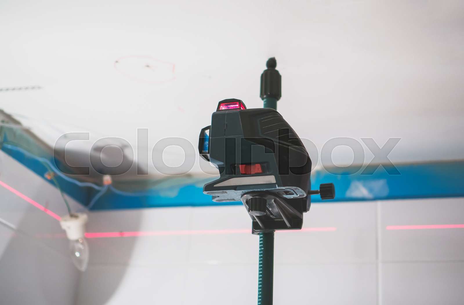 Laser level tool. Installing of Stretch Ceiling. | Stock image | Colourbox