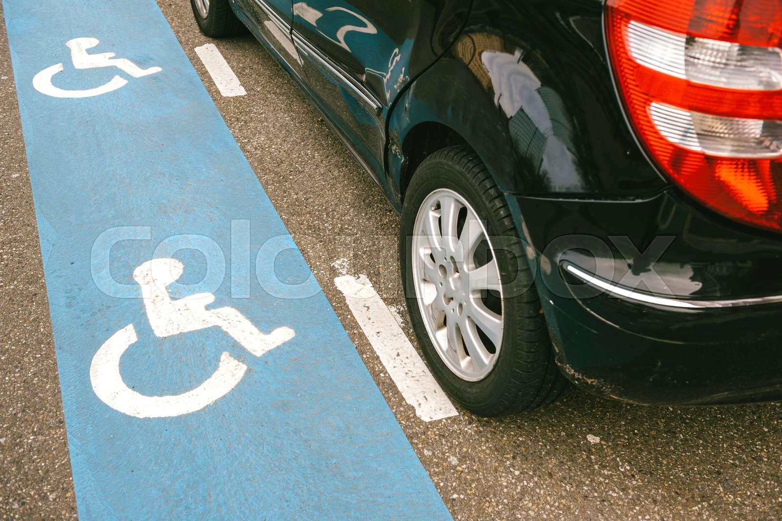 Car parked on the disabled blue sign | Stock image | Colourbox