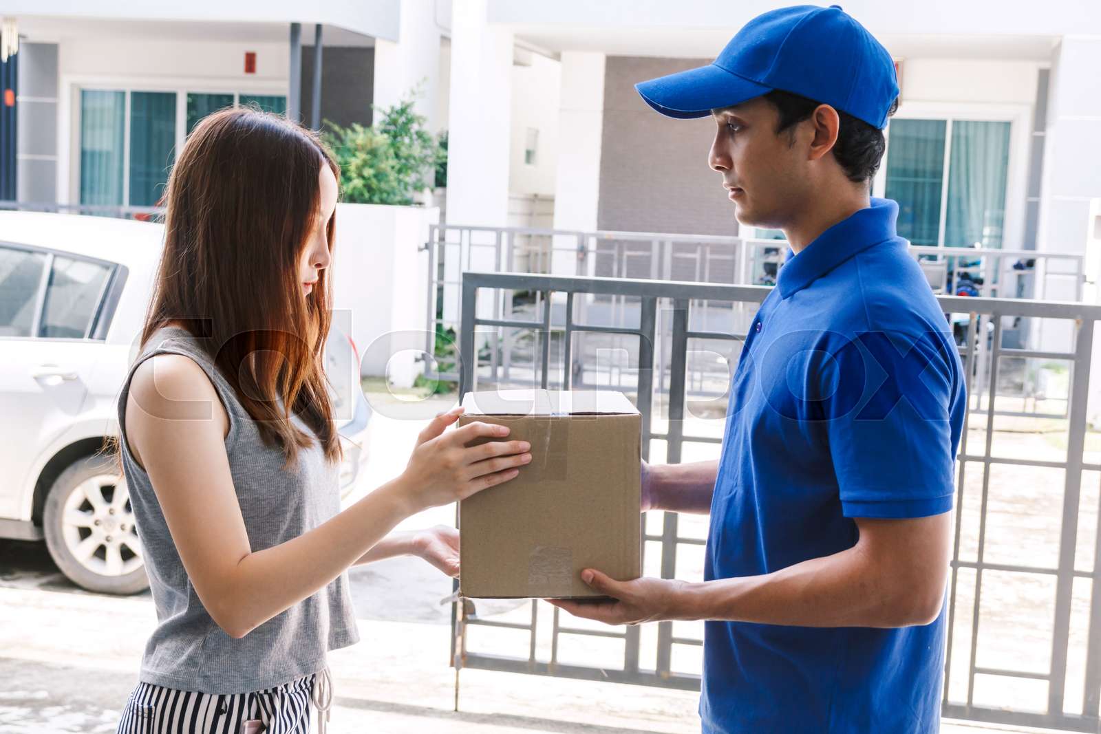 Woman accepting a delivery boxes from delivery man | Stock image ...