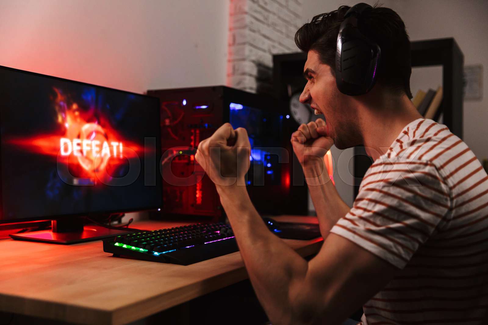 Side view of Screaming displeased gamer playing video games | Stock ...