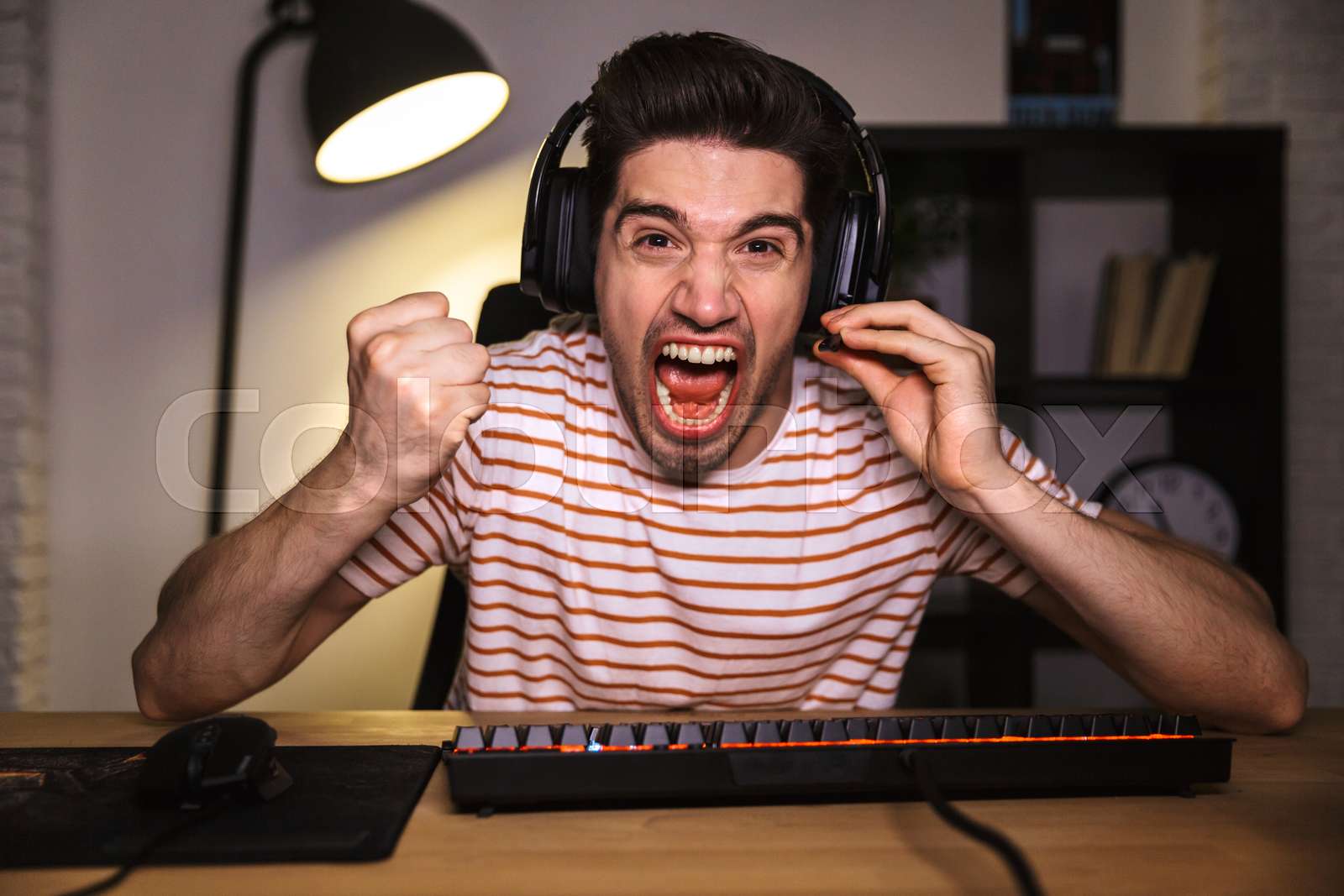 Screaming angry gamer playing video games on computer | Stock image ...
