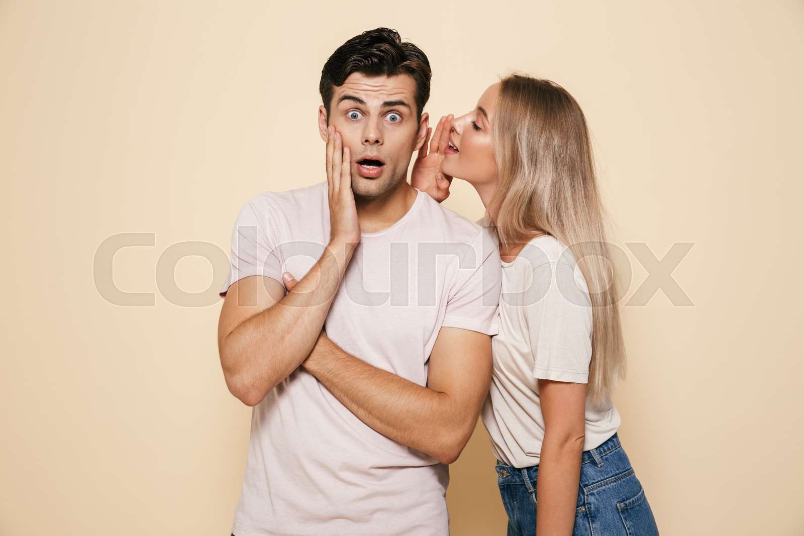 Portrait of a shocked young couple standing together | Stock image ...