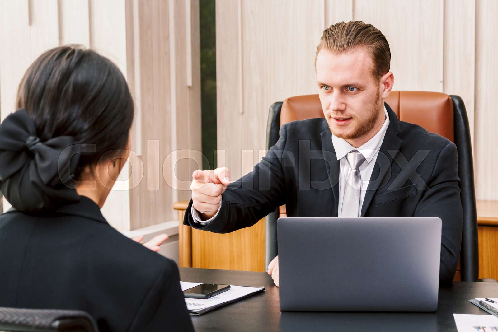 Businessman angry with his workers in office | Stock image | Colourbox