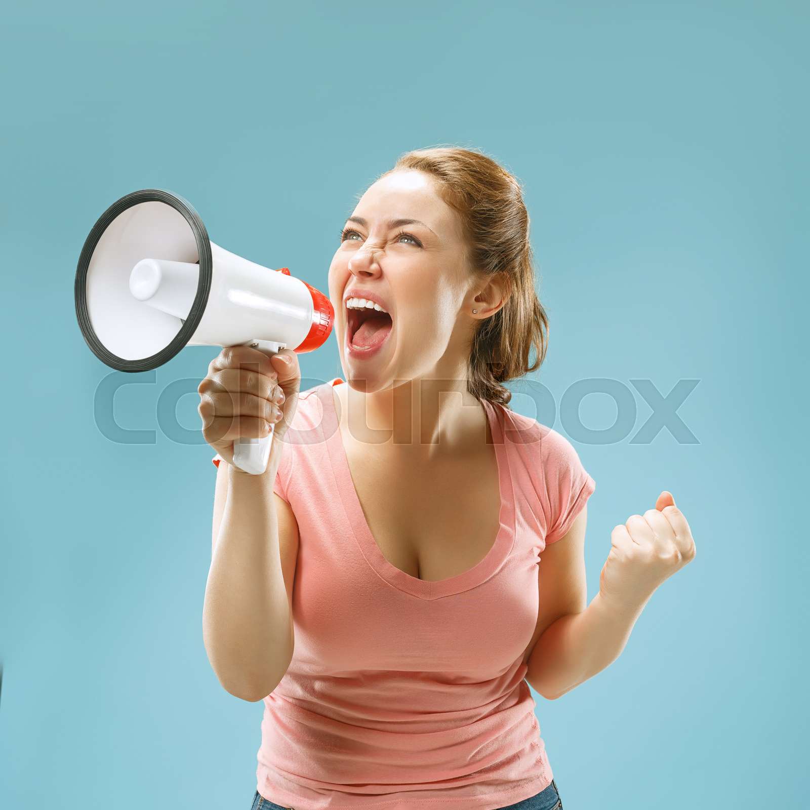 Woman making announcement with megaphone | Stock image | Colourbox