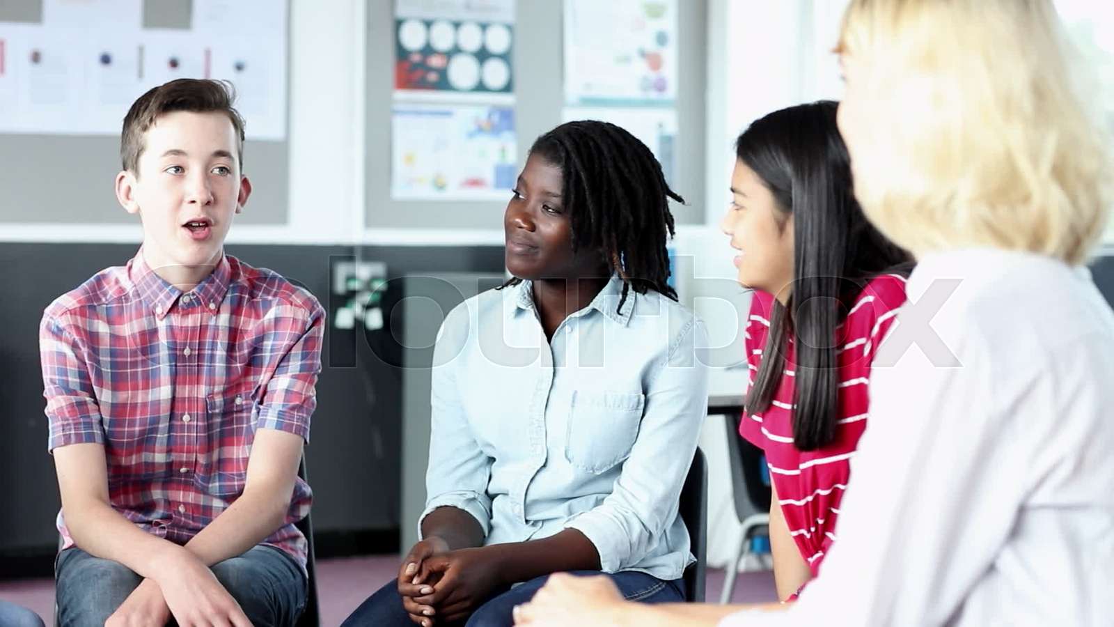 Group Of High School Students Having Informal Discussion With Female ...