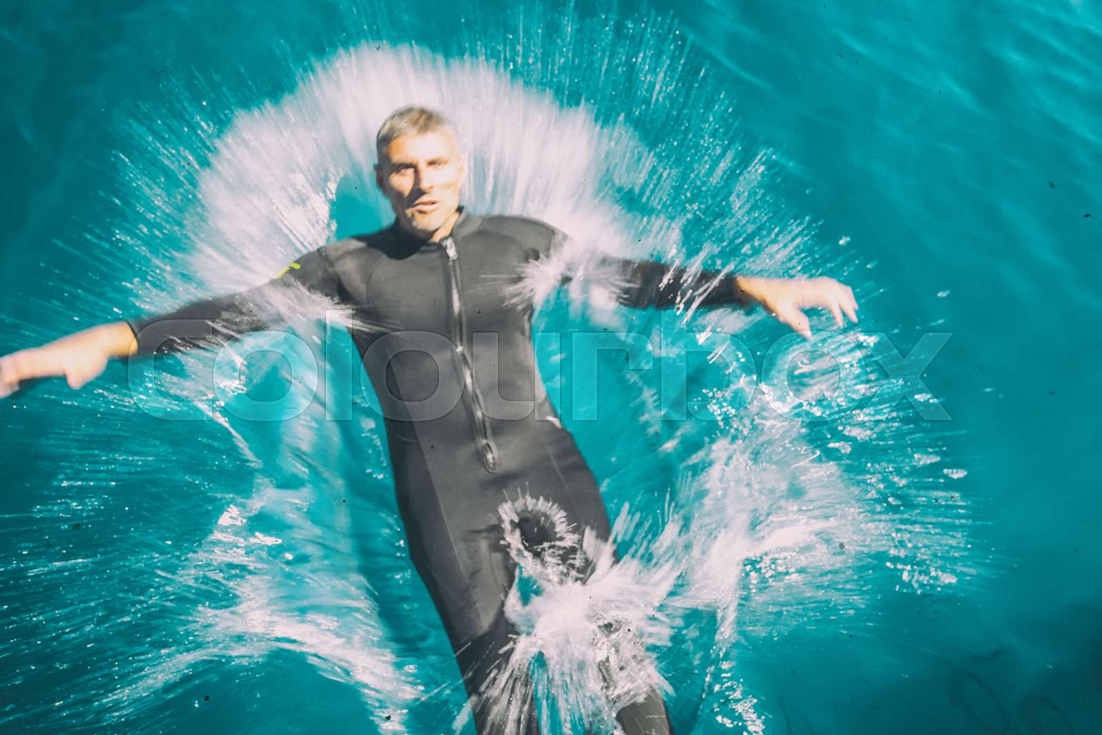 Man diving in the water. Ocean spash after the jump | Stock image ...