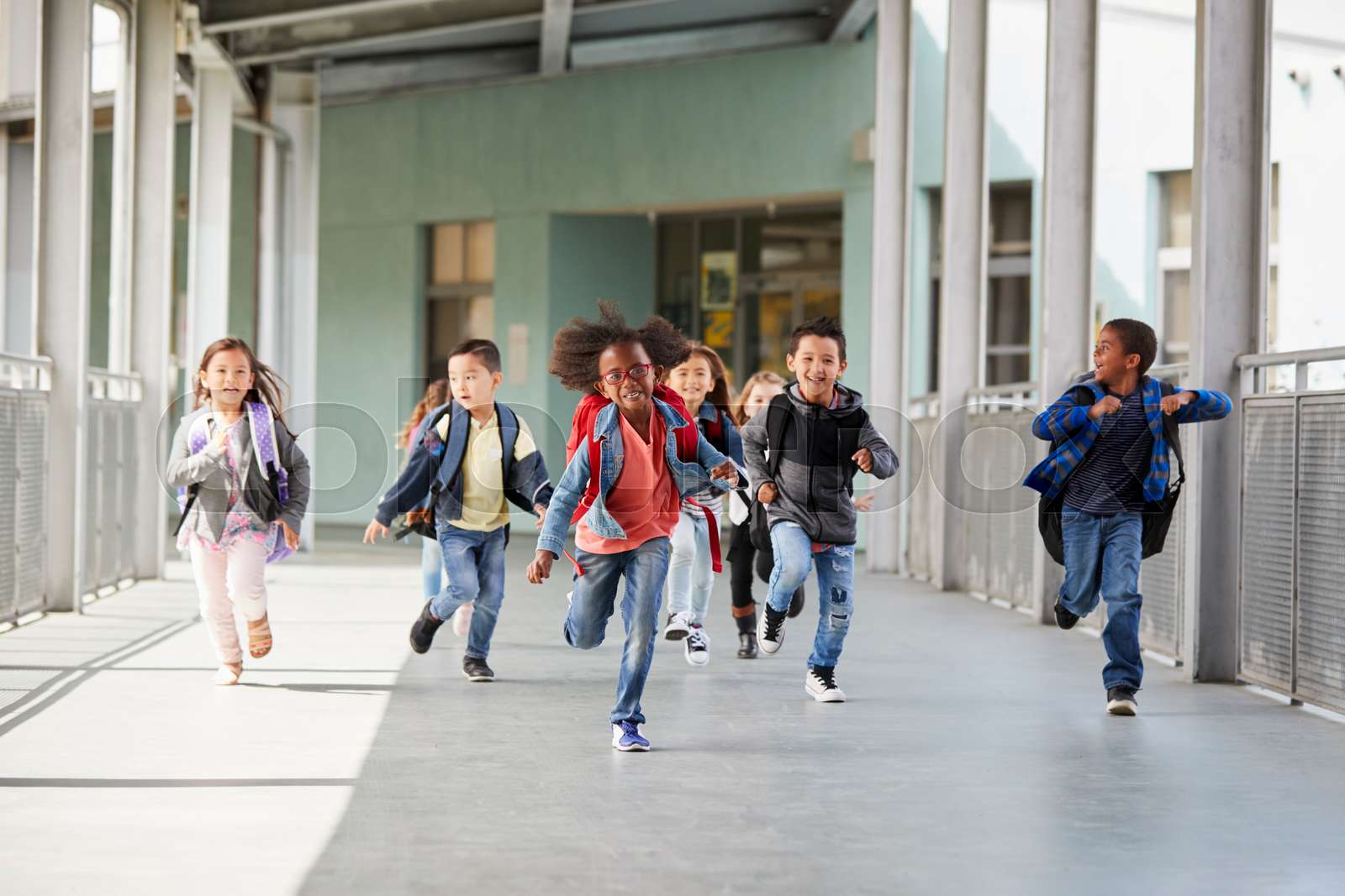 Elementary school kids running in a corridor in the school | Stock ...