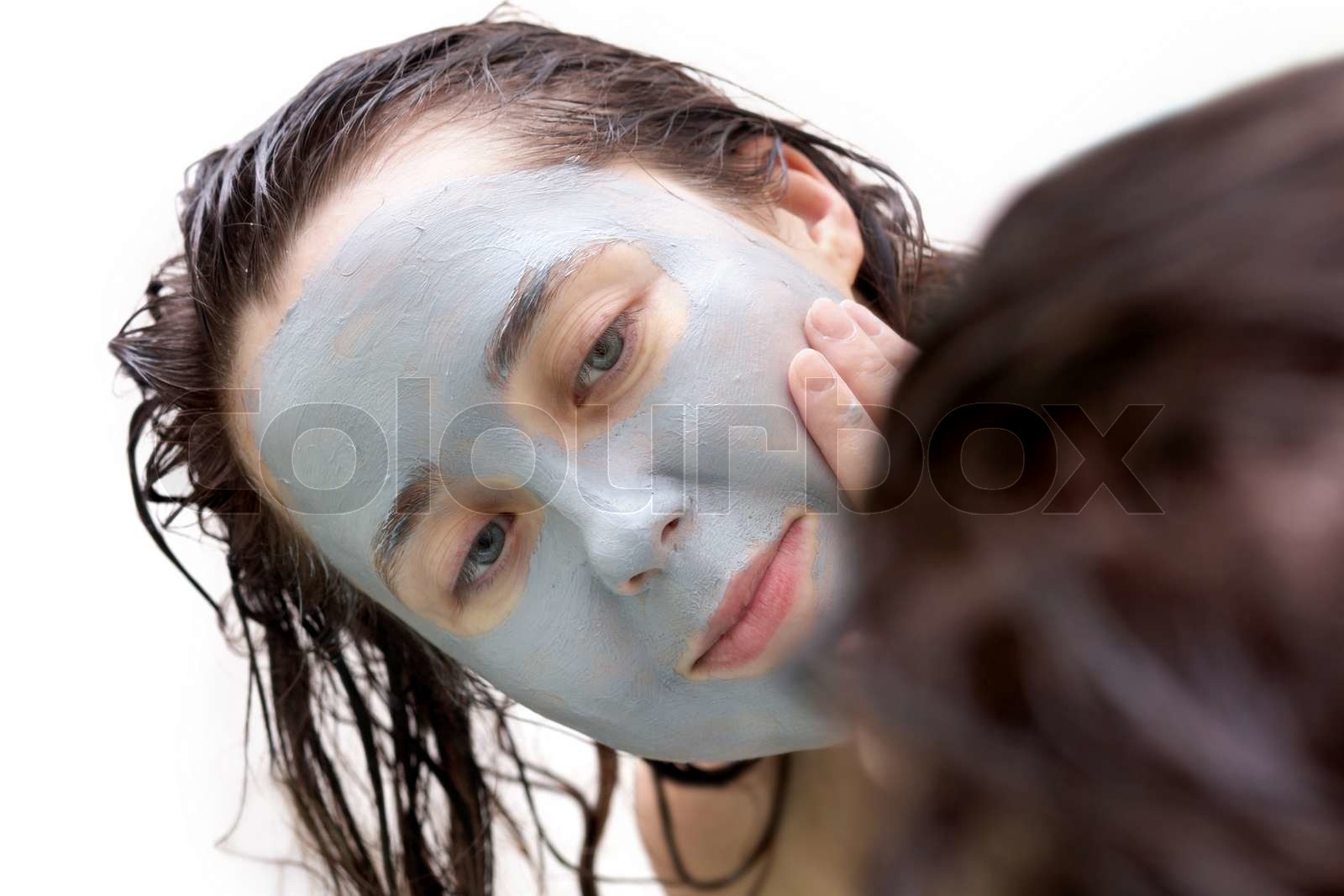 Girl putting a mud mask | Stock image | Colourbox