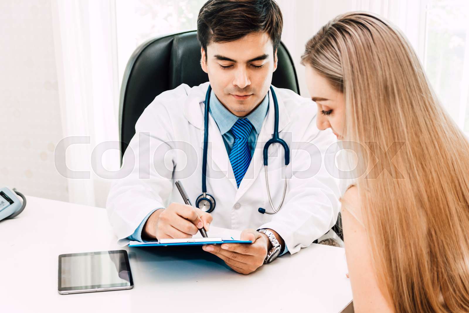 Doctor consulting and check up information with female patien on ...