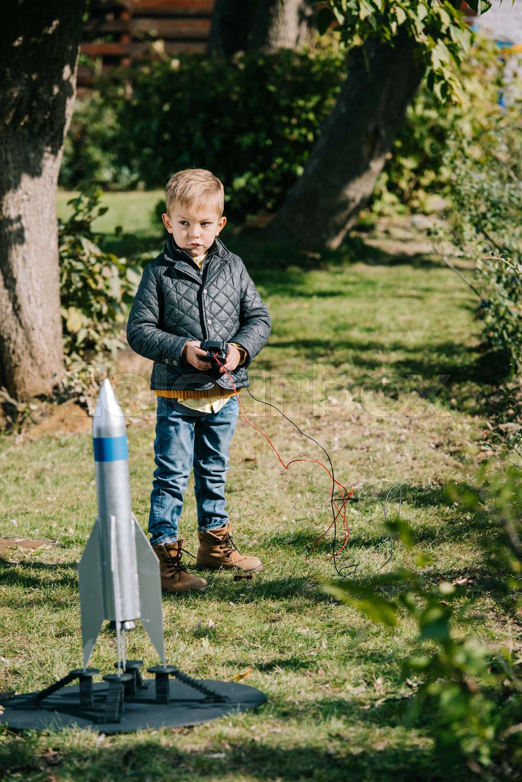 cute little boy launching model rocket outdoor | Stock image | Colourbox