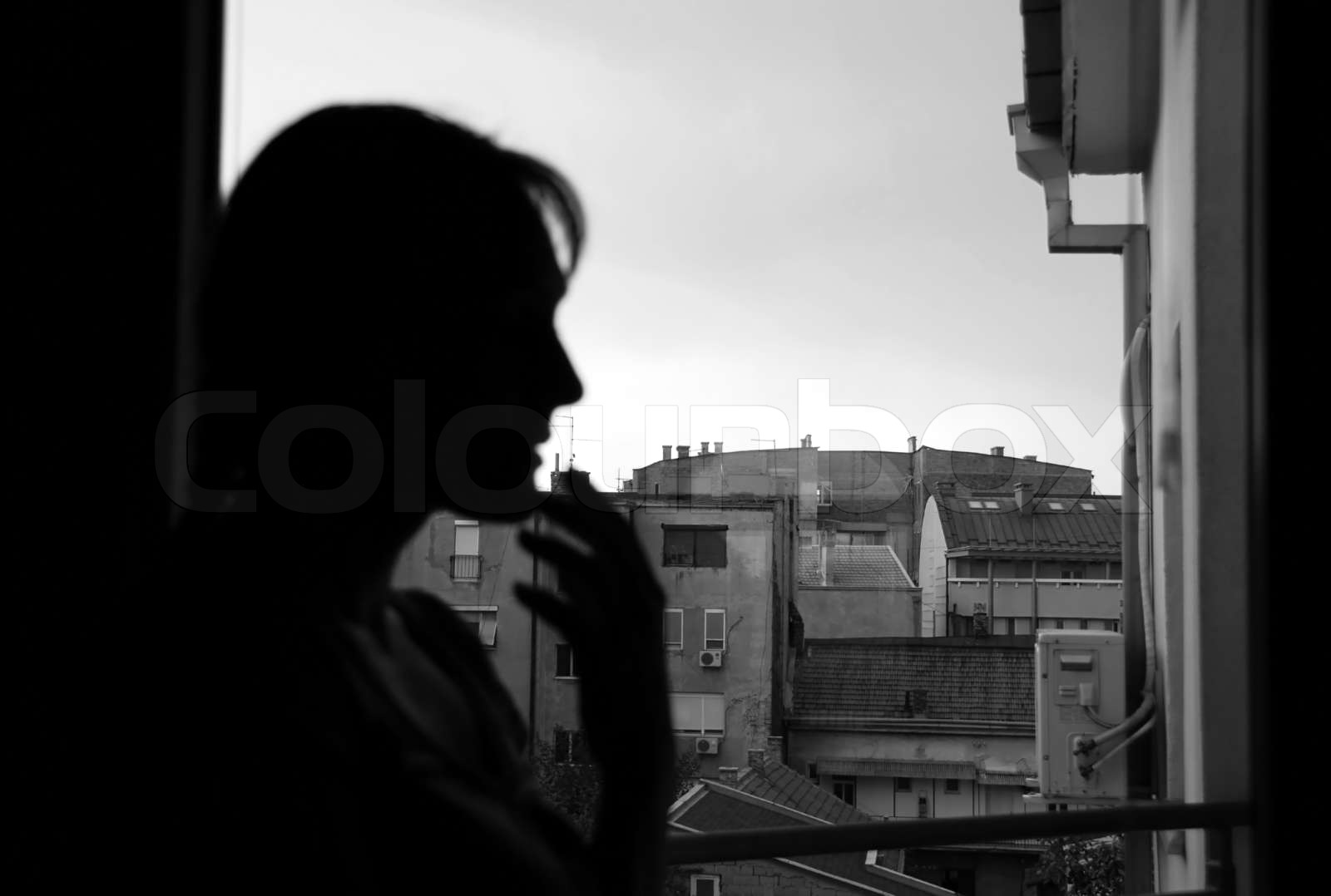 Female silhouette by window | Stock image | Colourbox