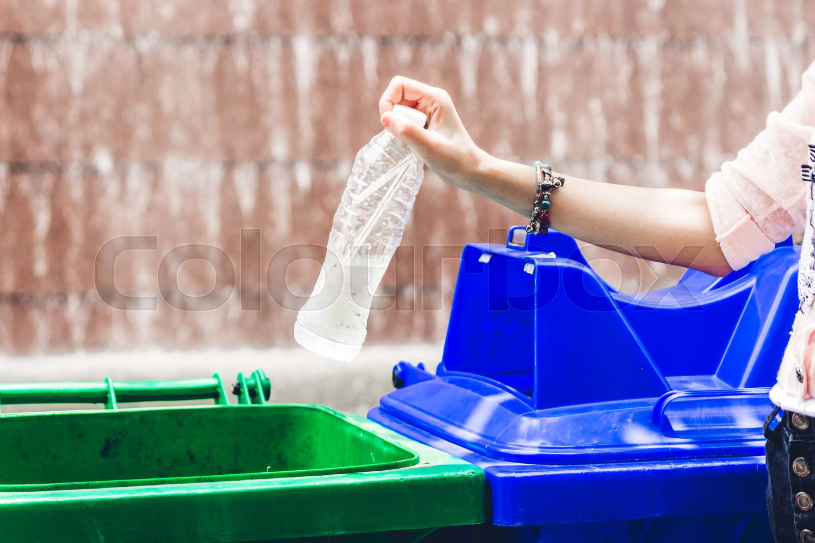 Woman hand throwing plastic water bottle in recycling bin | Stock image ...