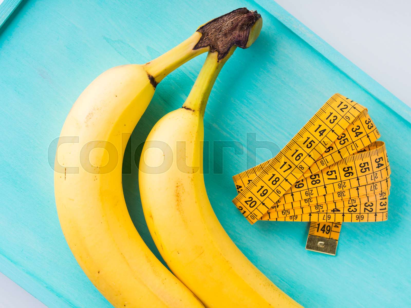 Two bananas with measuring meter | Stock image | Colourbox