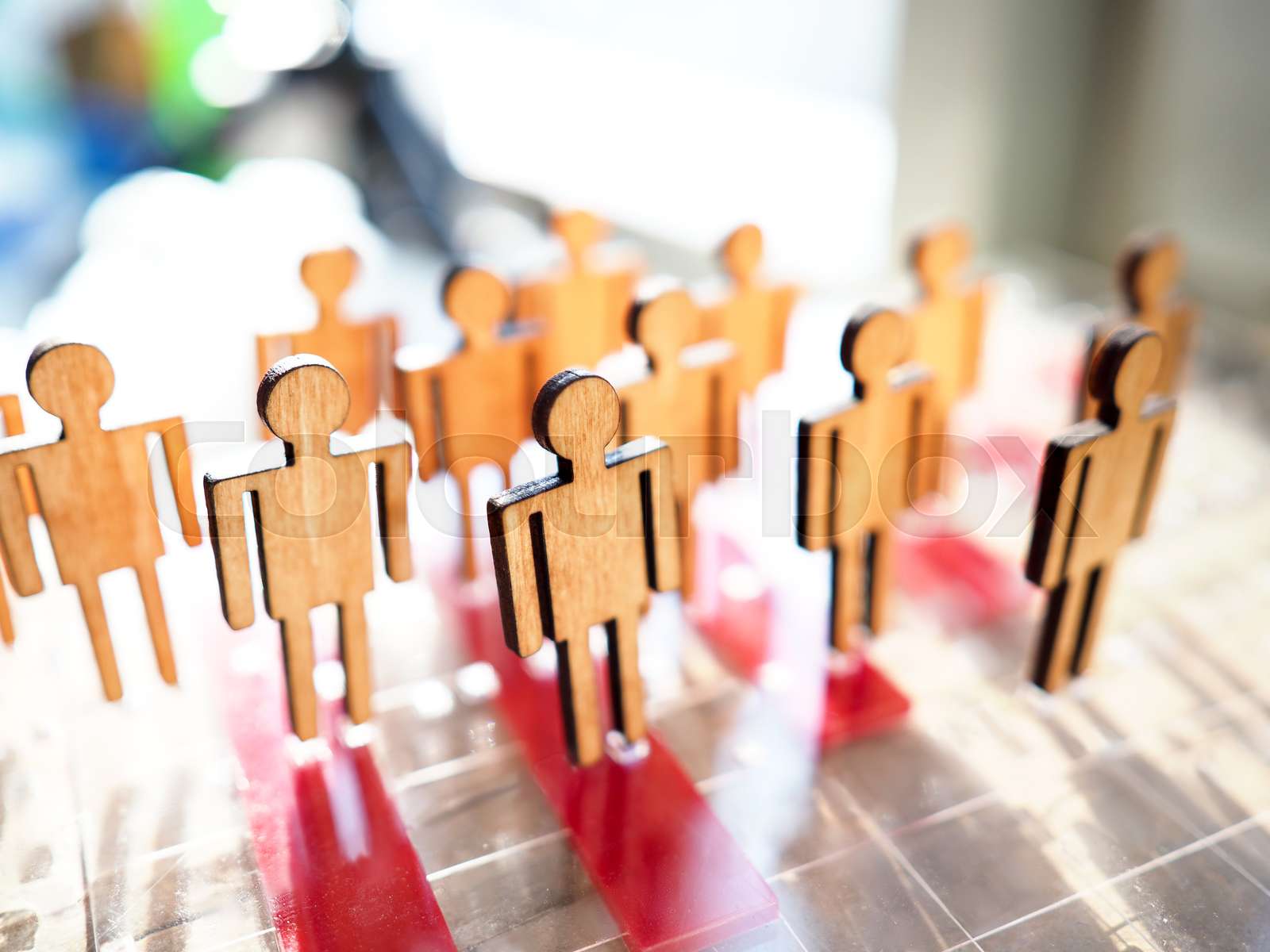 Little wooden toy people figures stand in row | Stock image | Colourbox
