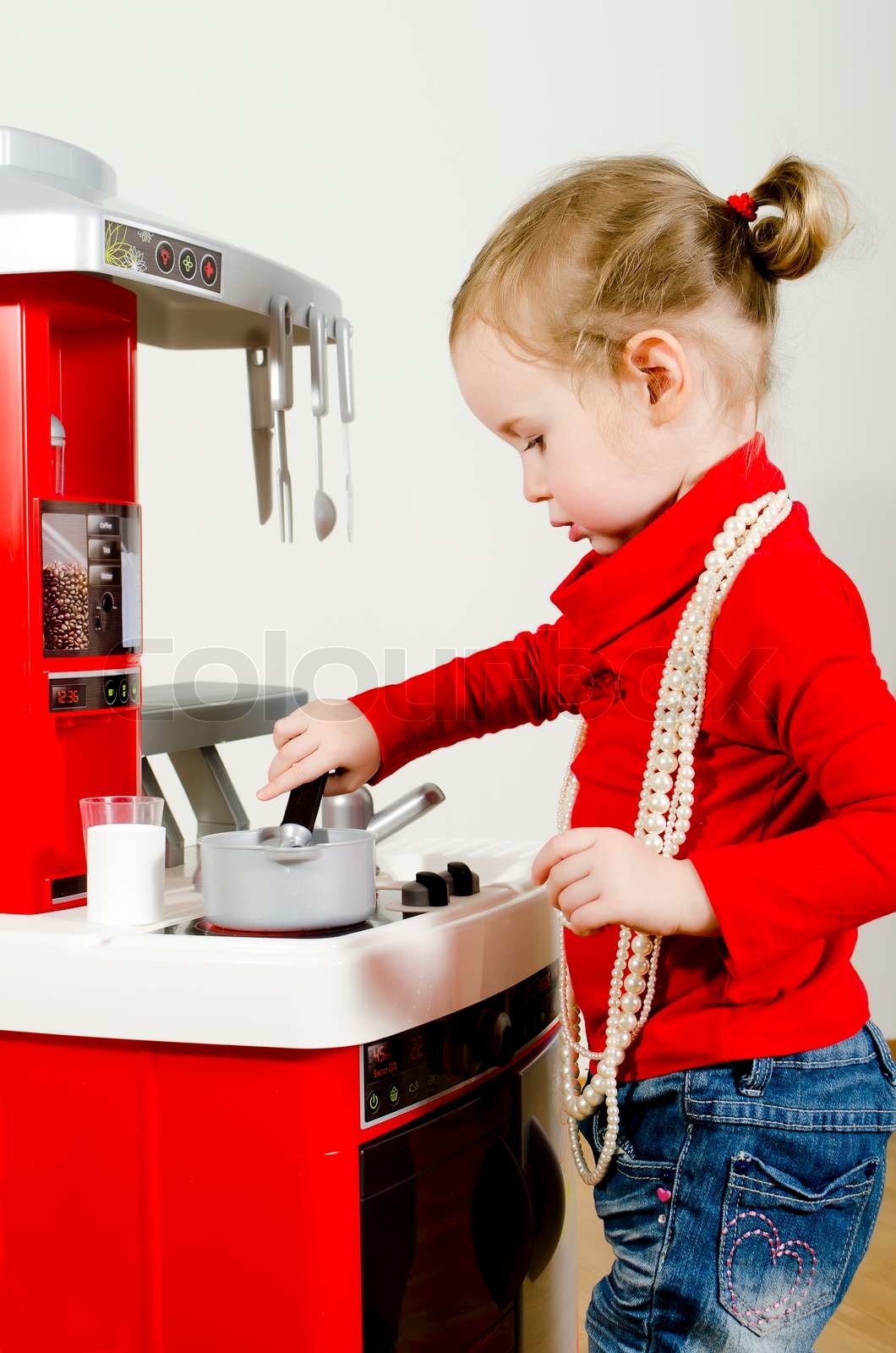 Little cute girl playing in children's kitchen | Stock image | Colourbox