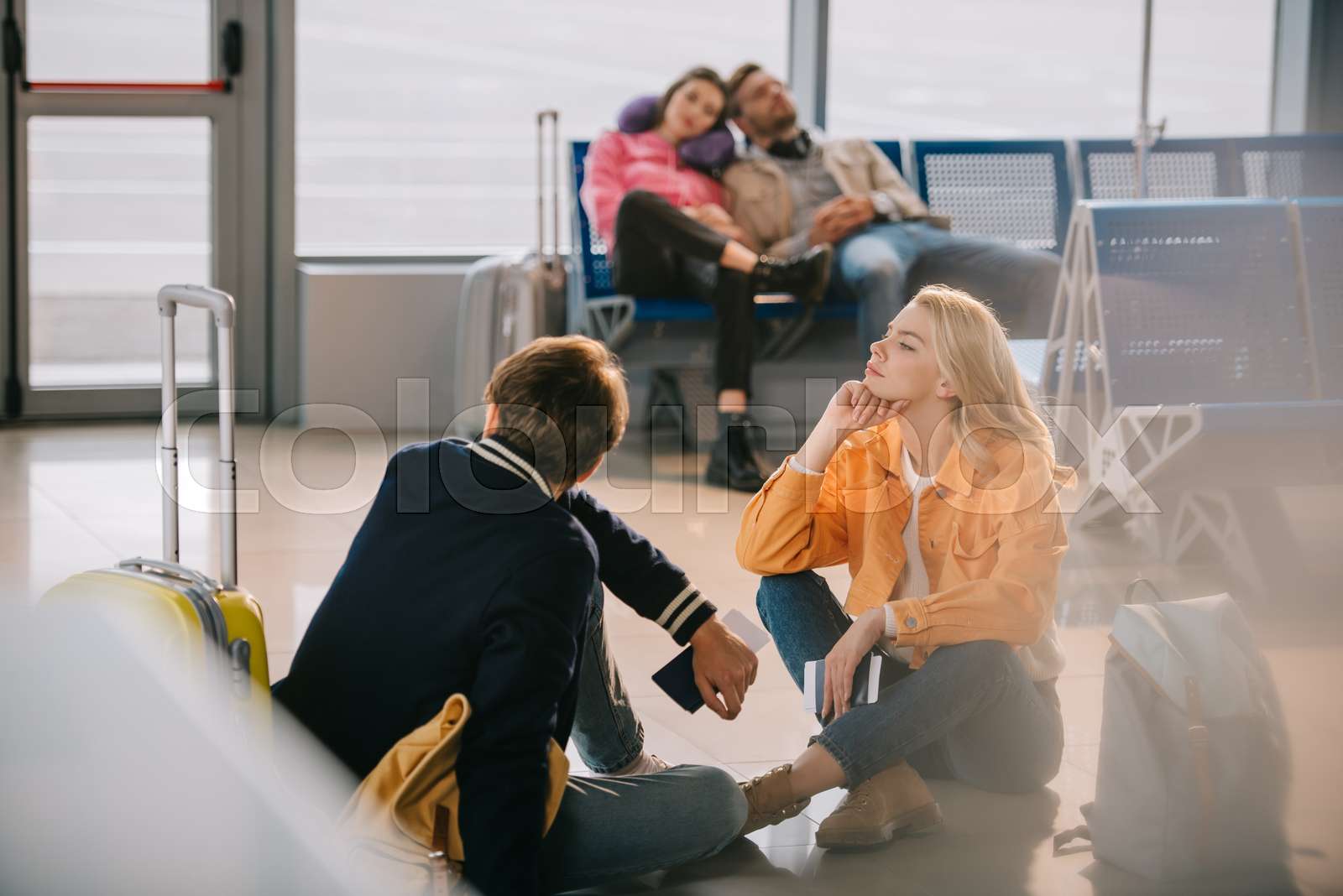 young people with luggage waiting in airport terminal | Stock image ...