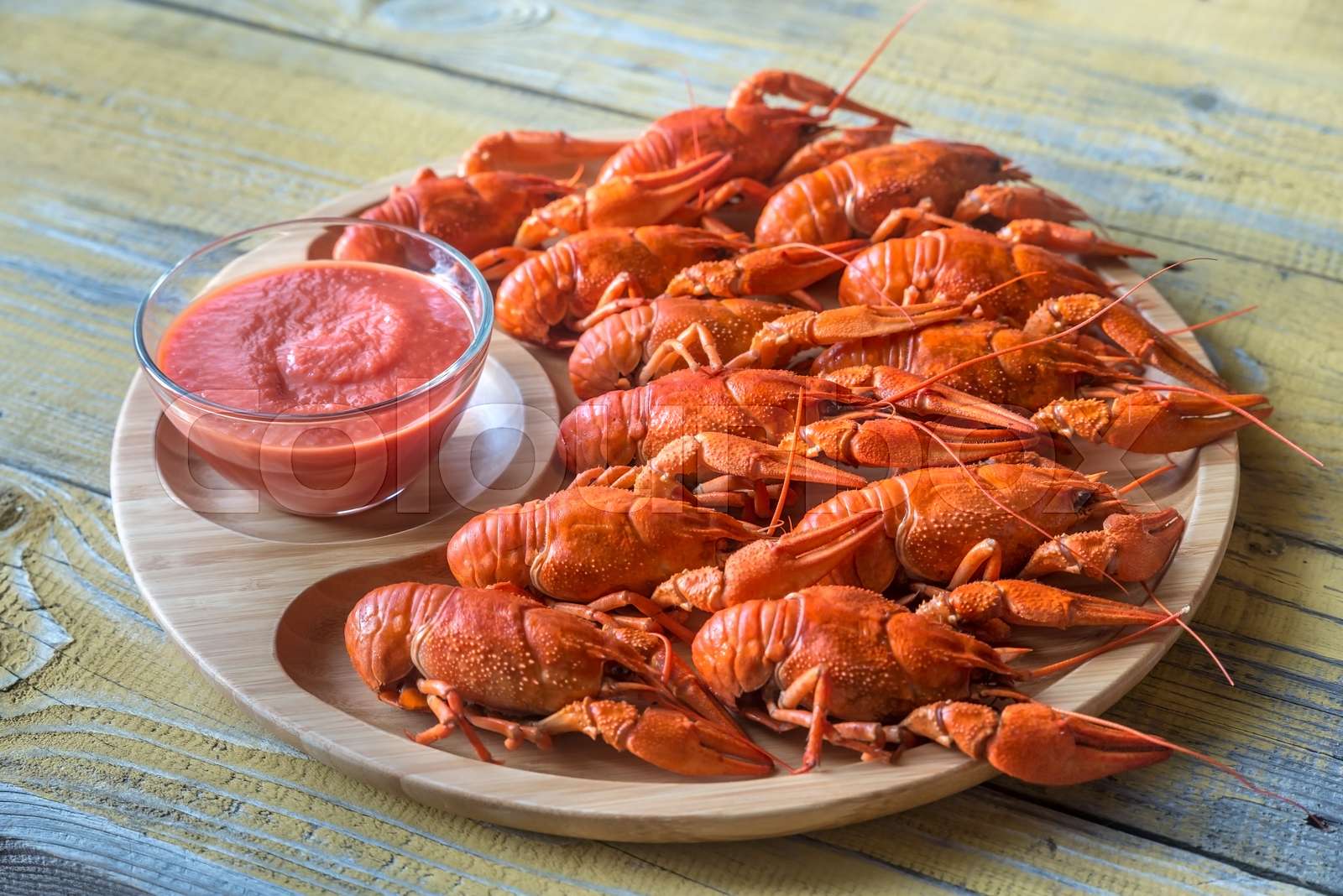 Dish of boiled crayfish with sauce | Stock image | Colourbox