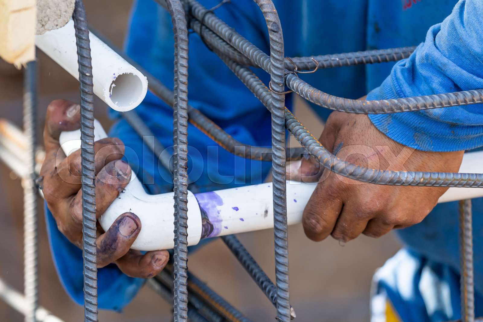 Plumber Installing PVC Pipe at Construction Site | Stock image | Colourbox