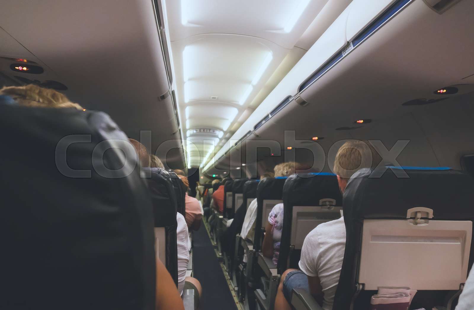 Interior inside of the plane with passengers. | Stock image | Colourbox