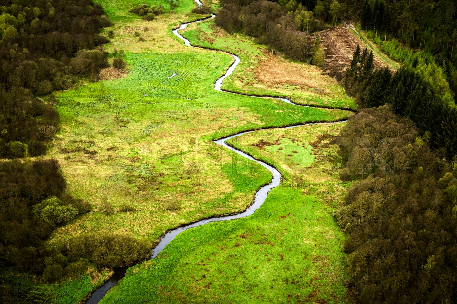 Small river going through a green area with fields | Stock image ...