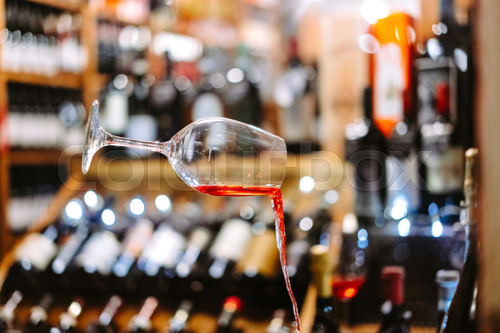 Glass of Wine Falling Mid Air with Spill | Stock image | Colourbox