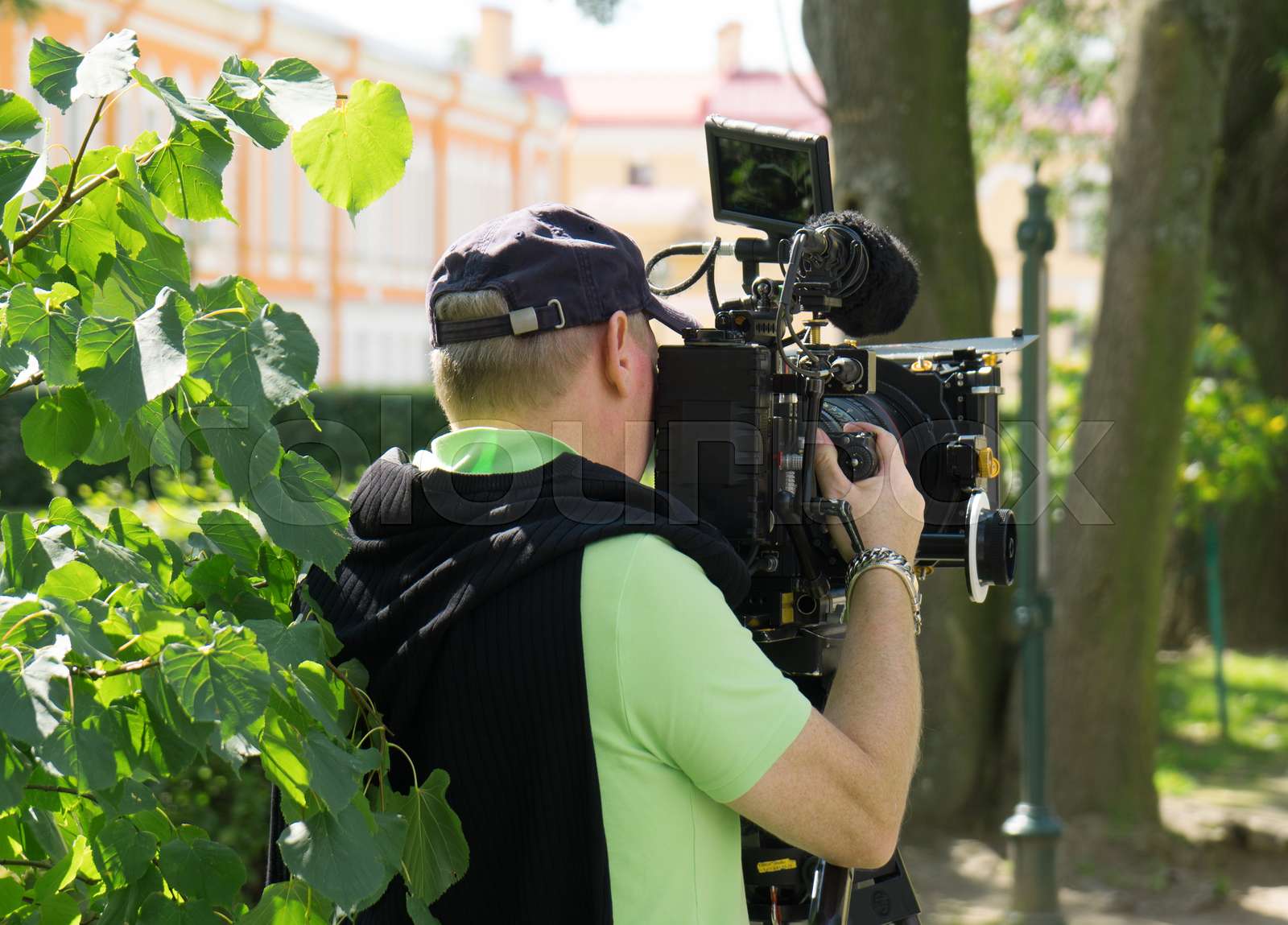 Journalist shooting with professional TV camera. | Stock image | Colourbox