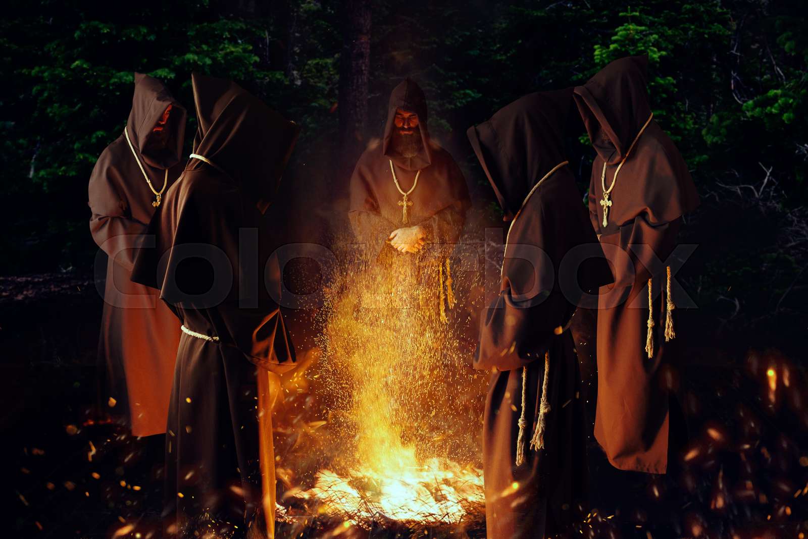 Medieval monks praying against a fire in the night | Stock image ...