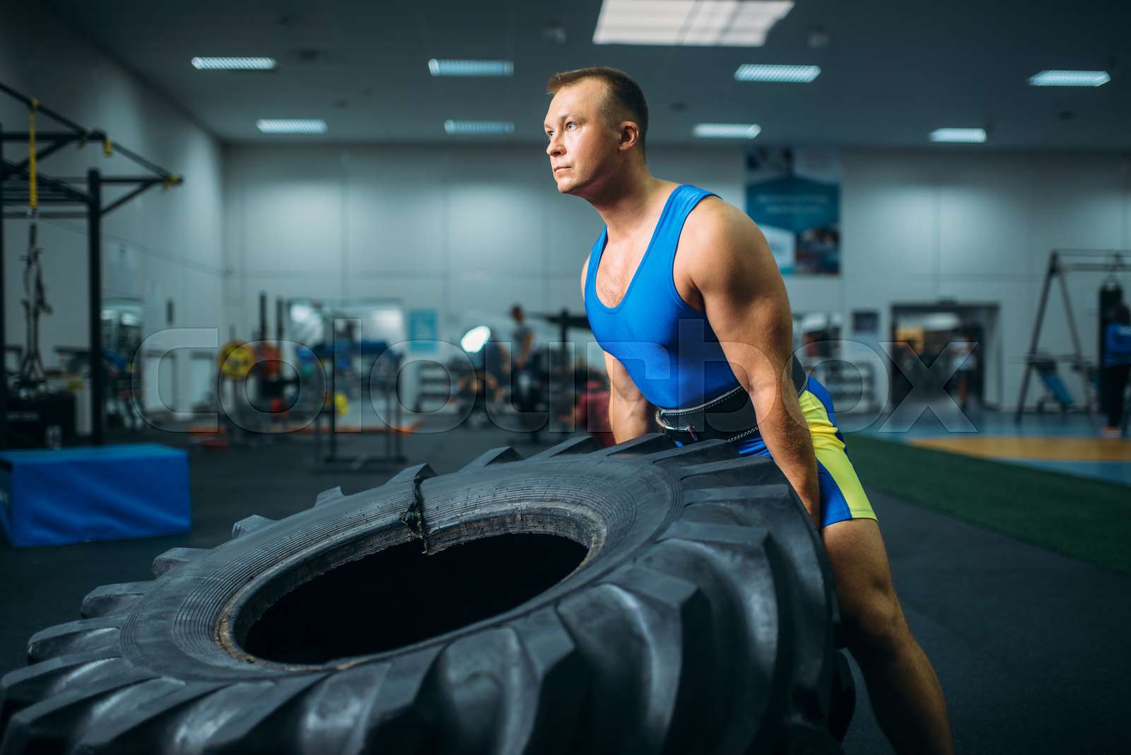 Athlete doing exercise with truck tyre, crossfit | Stock image | Colourbox