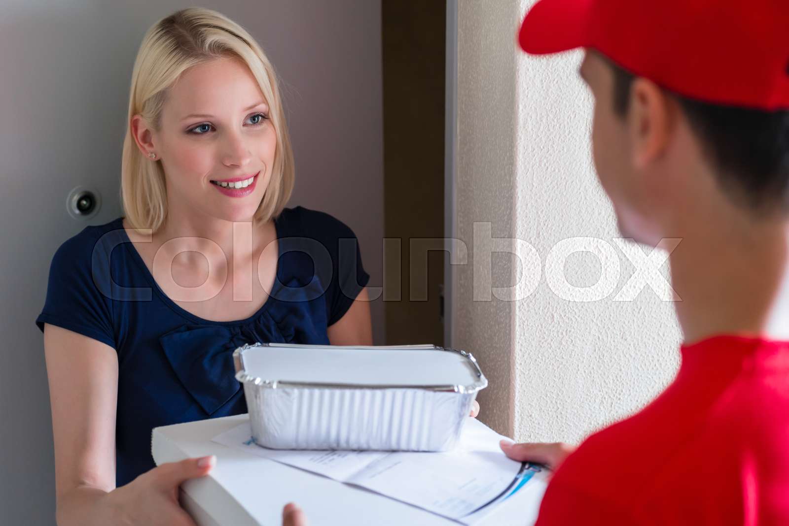 Delivery man giving fast food order to customer | Stock image | Colourbox
