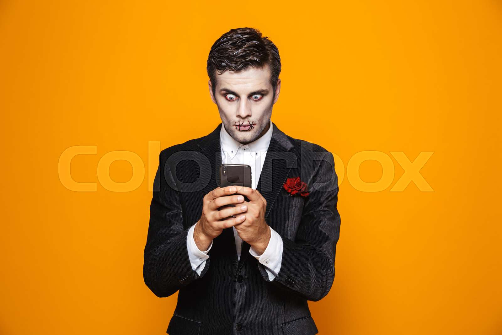 Shocked zombie man groom using smartphone isolated | Stock image ...