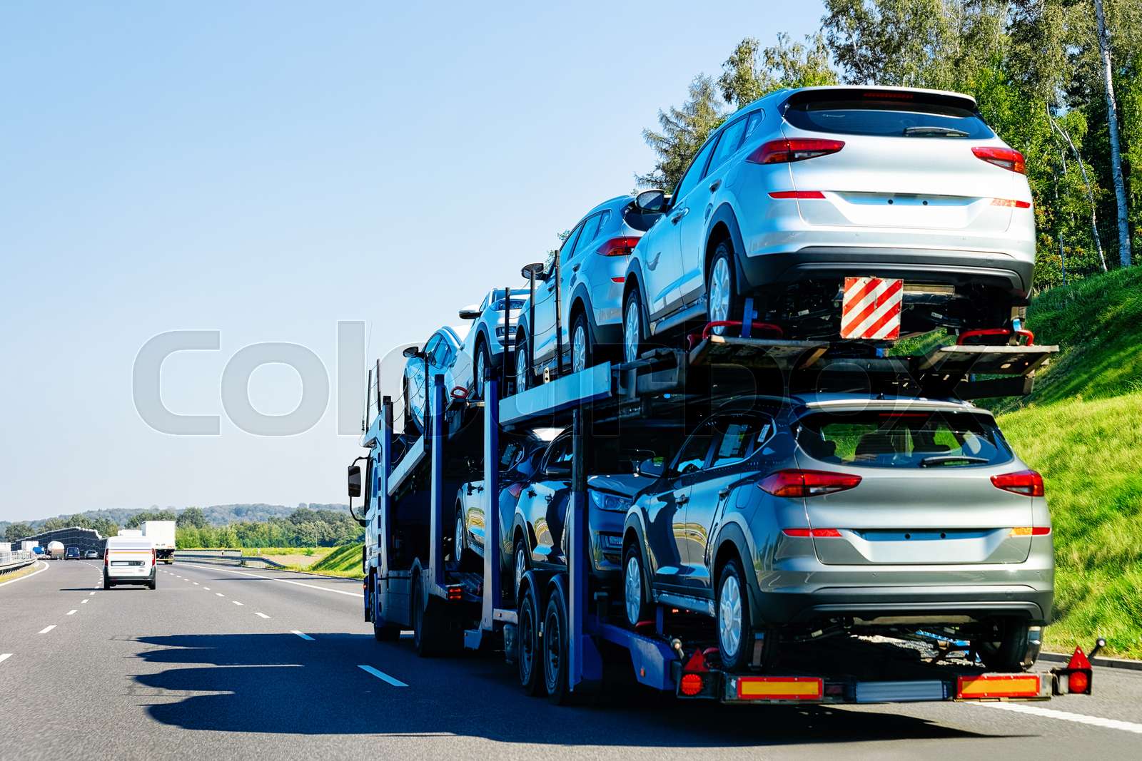 Cars carrier truck on asphalt road in Poland | Stock image | Colourbox
