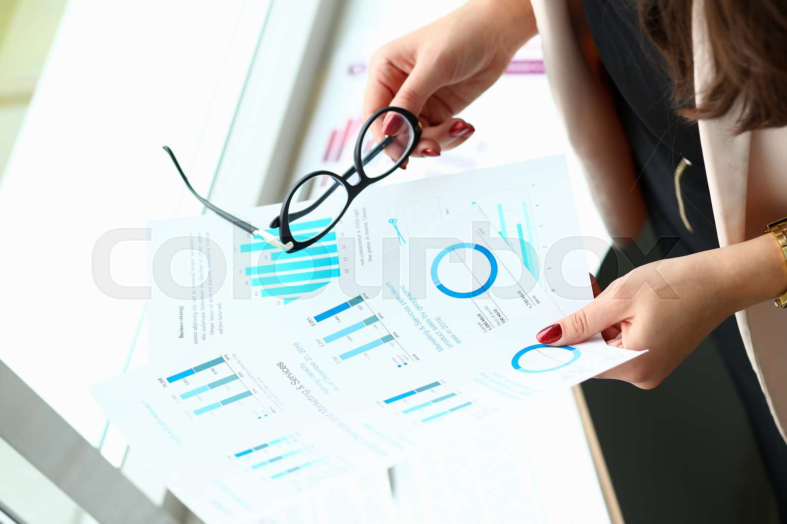 Businessman and businesswoman review graph | Stock image | Colourbox