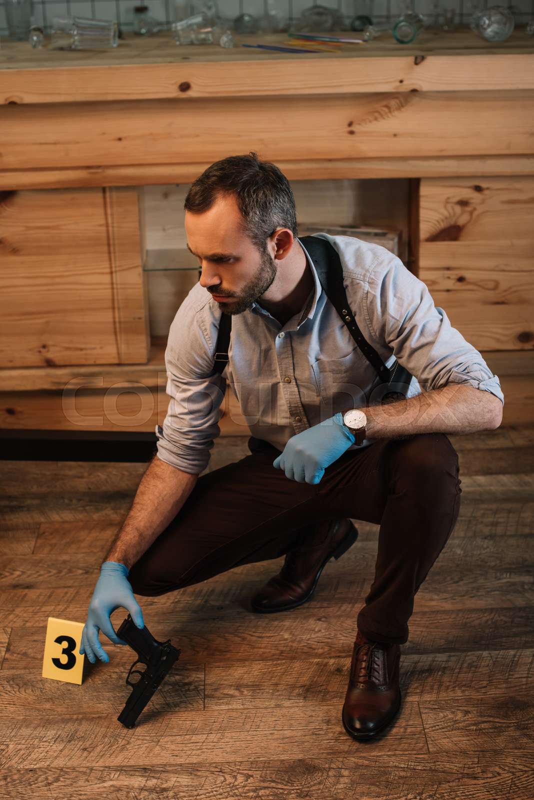 focused male detective collecting evidence gun at crime scene | Stock ...