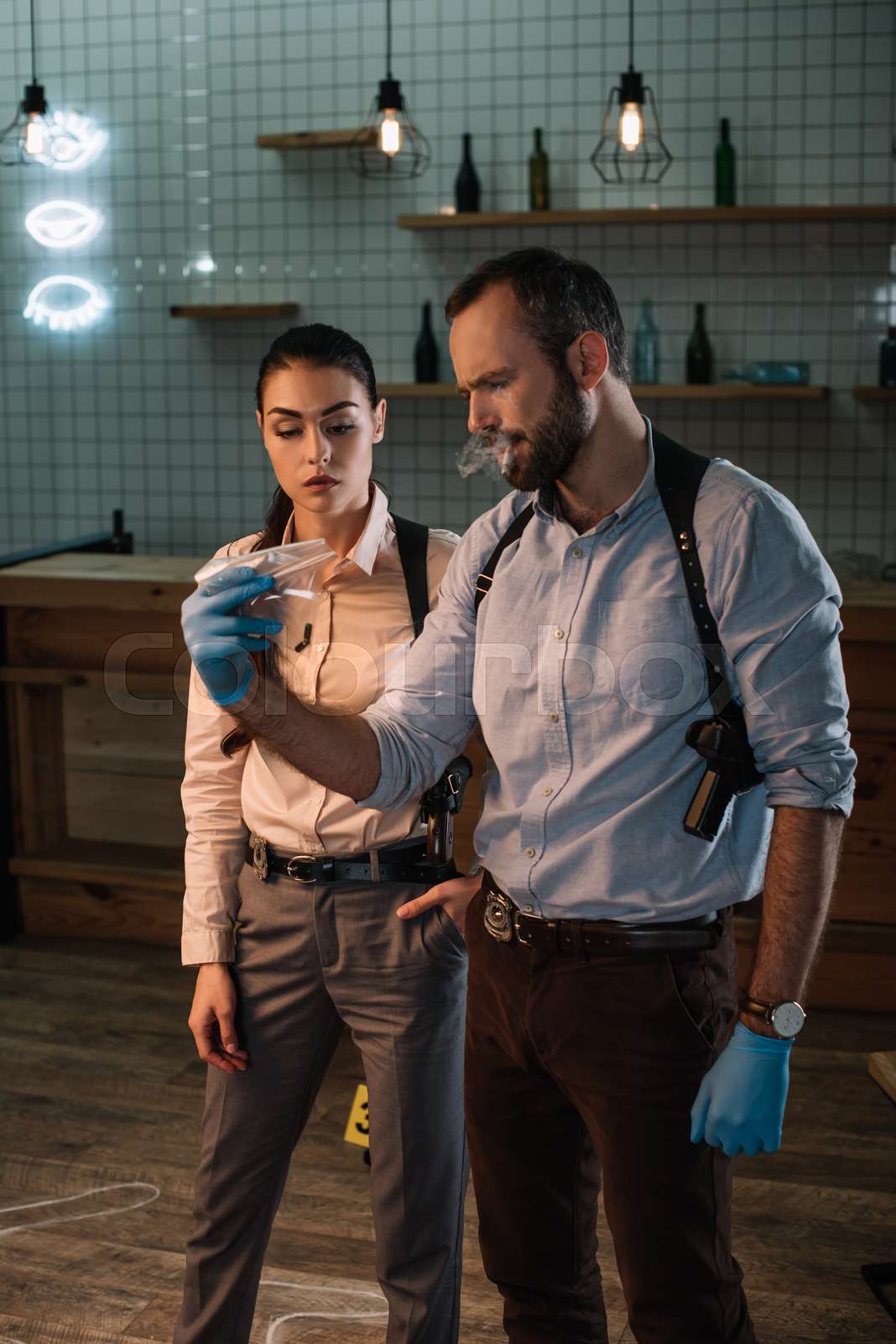 concentated female and male detectives discussing evidents and ...