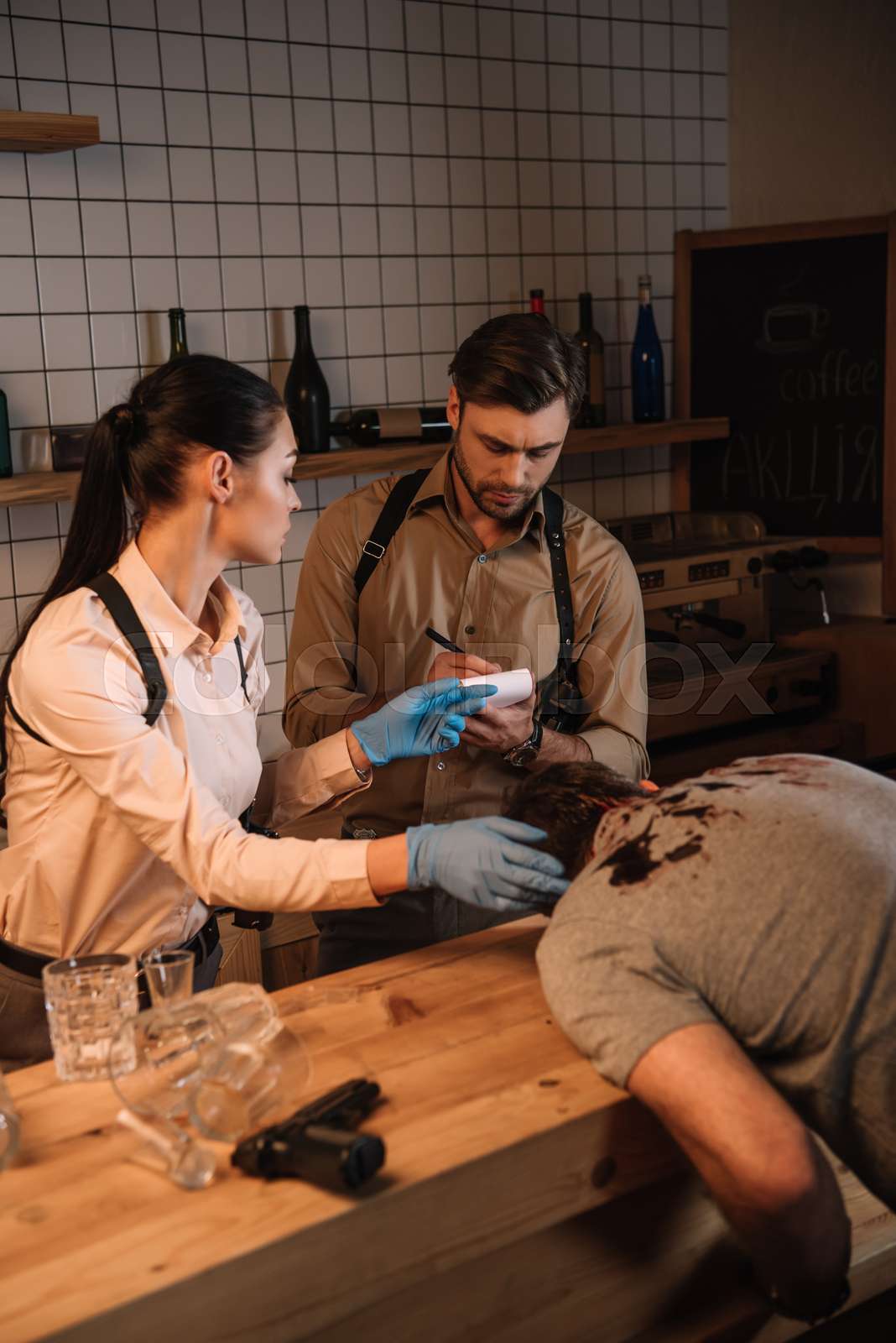 Concentated Female And Male Detectives Collecting Evidence From Dead