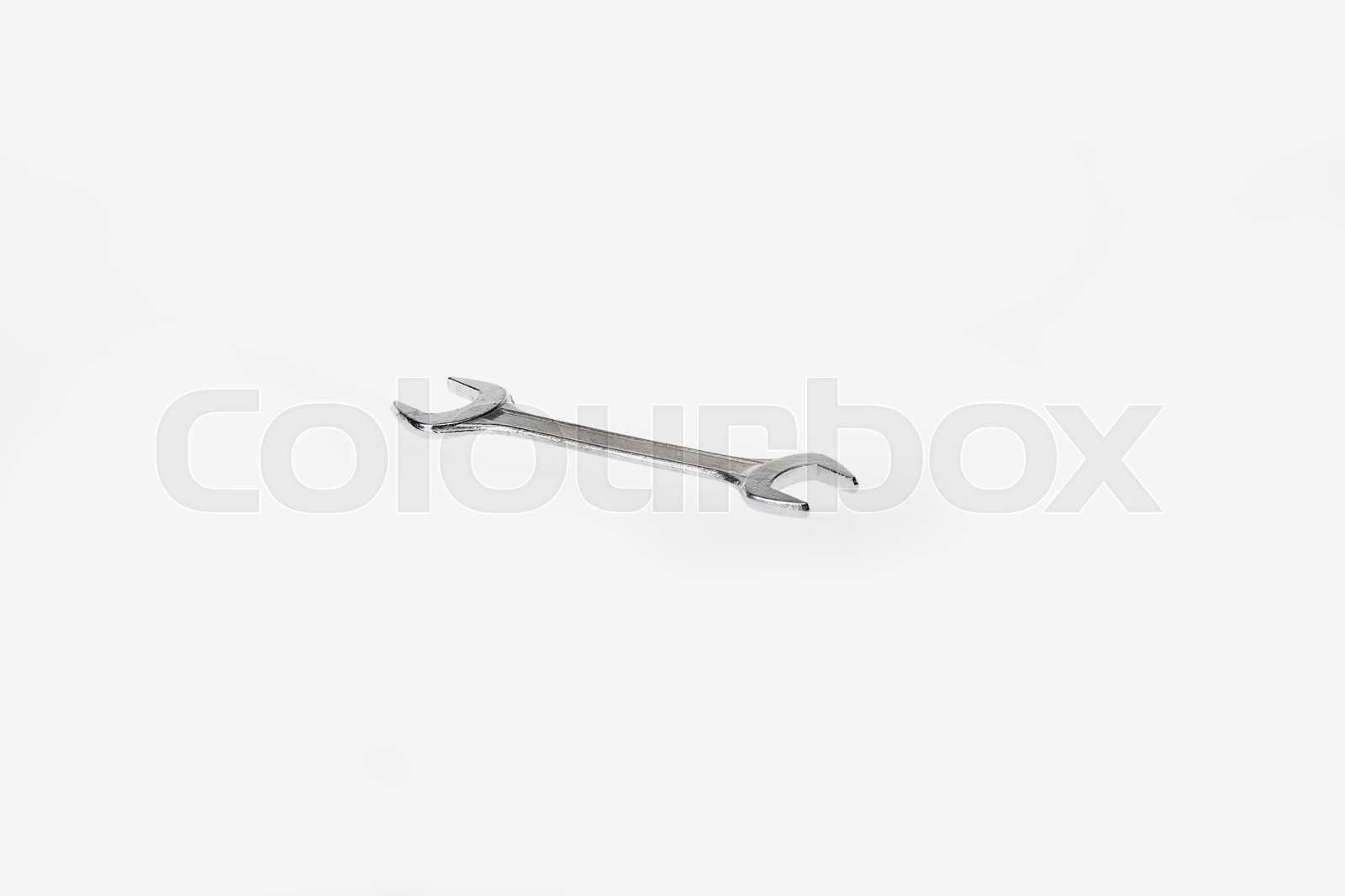 Silver colored wrench tool isolated on white | Stock image | Colourbox